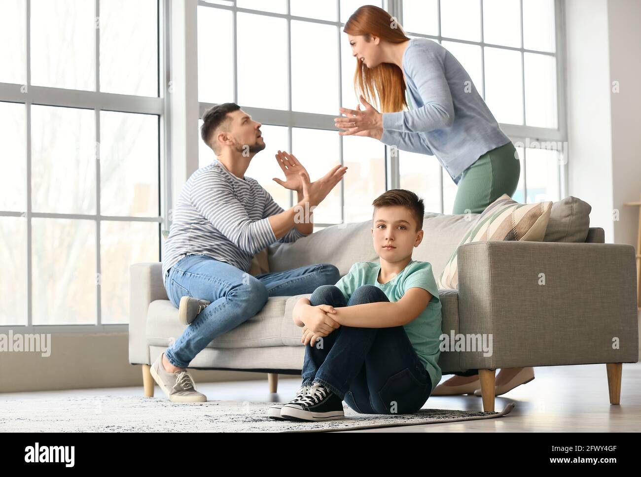 Sad little boy and his quarrelling parents at home Stock Photo - Alamy
