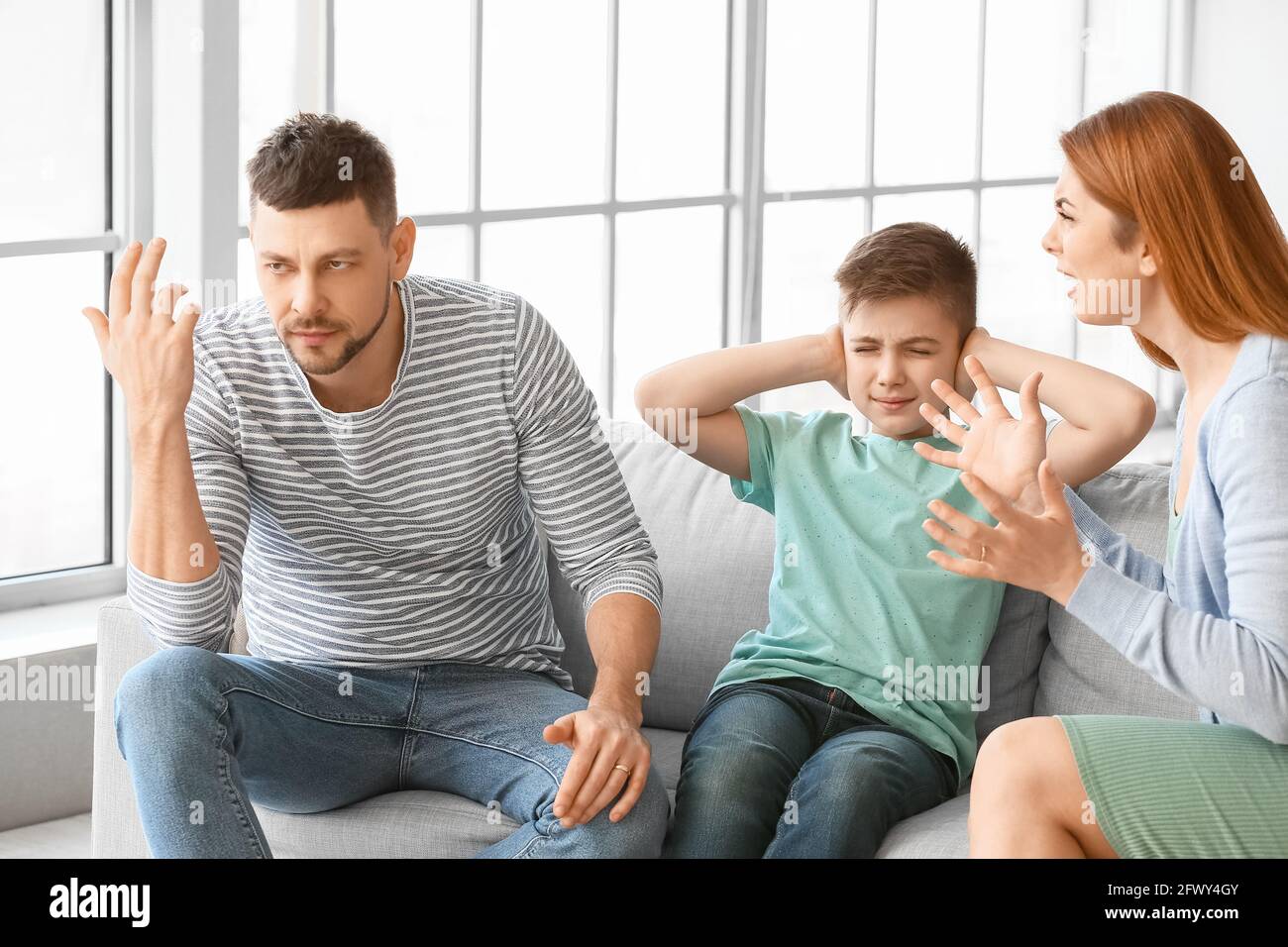 Sad little boy and his quarrelling parents at home Stock Photo - Alamy