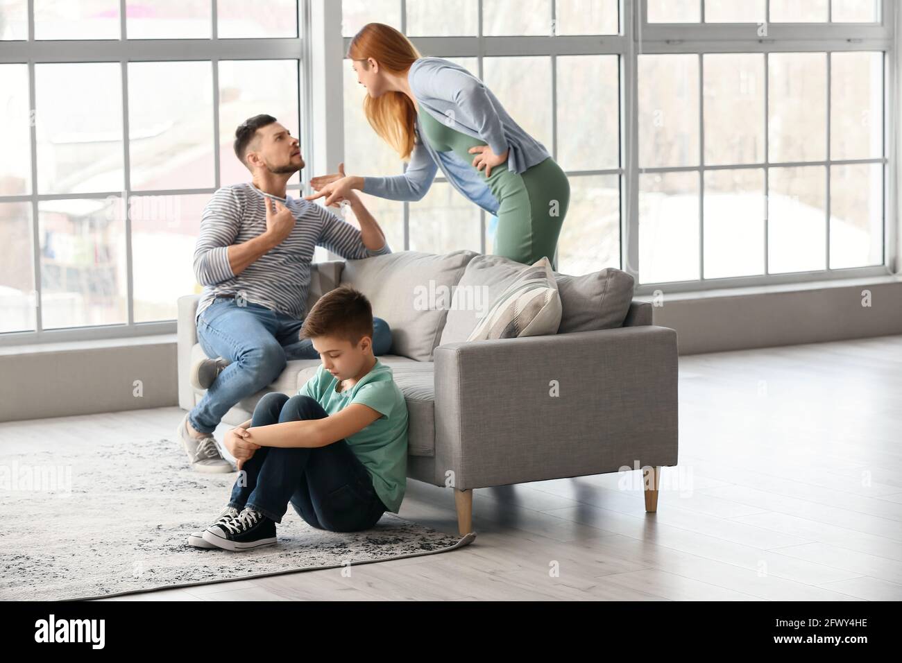 Sad little boy and his quarrelling parents at home Stock Photo - Alamy