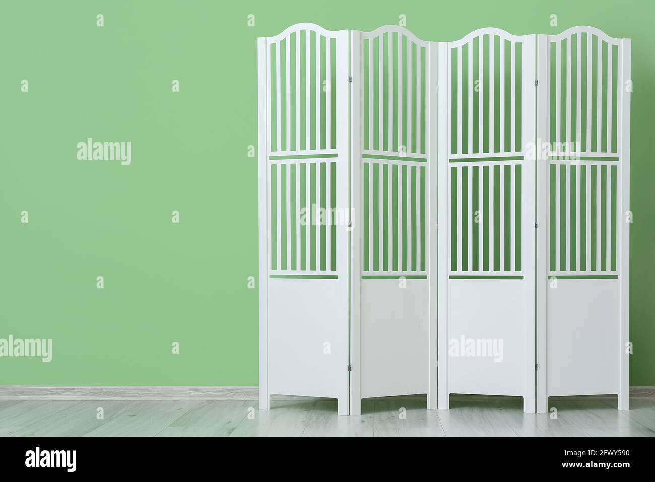 Modern folding screen near color wall Stock Photo - Alamy