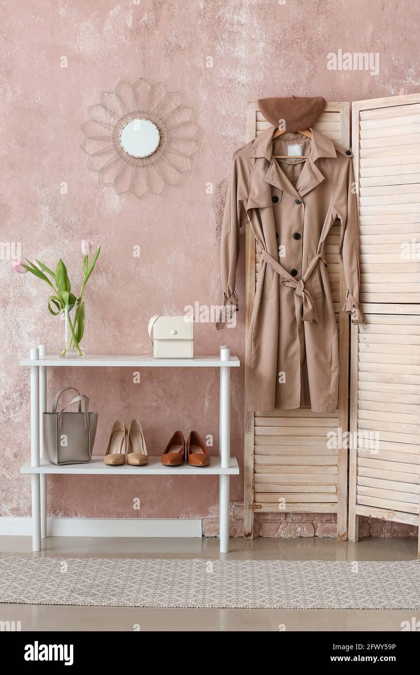 Interior of stylish hallway with folding screen Stock Photo - Alamy