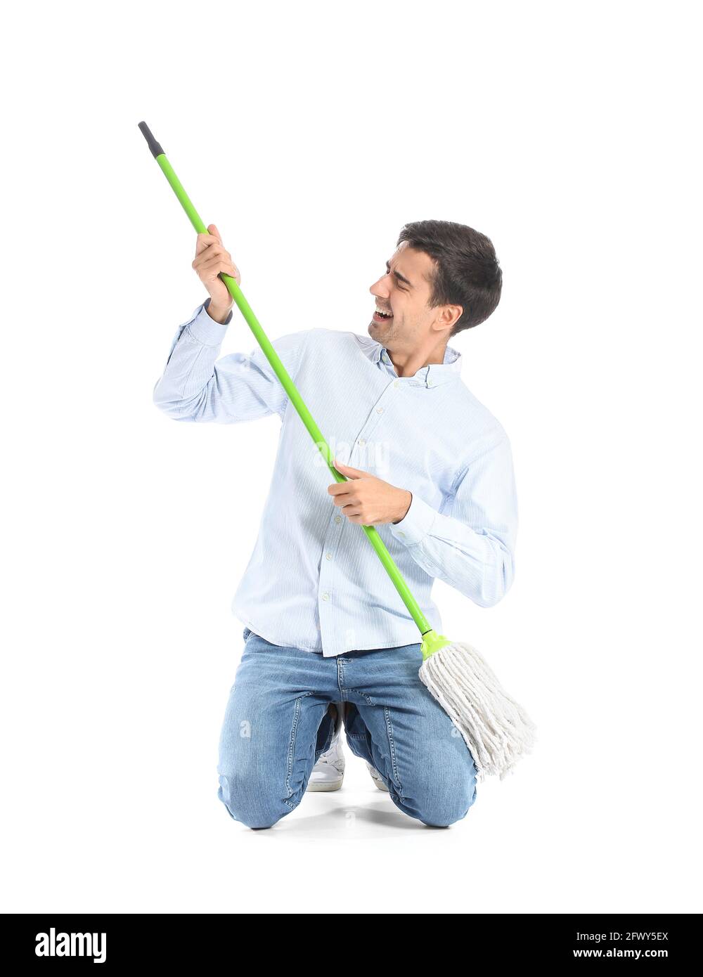 Young man with floor mop on white background Stock Photo - Alamy