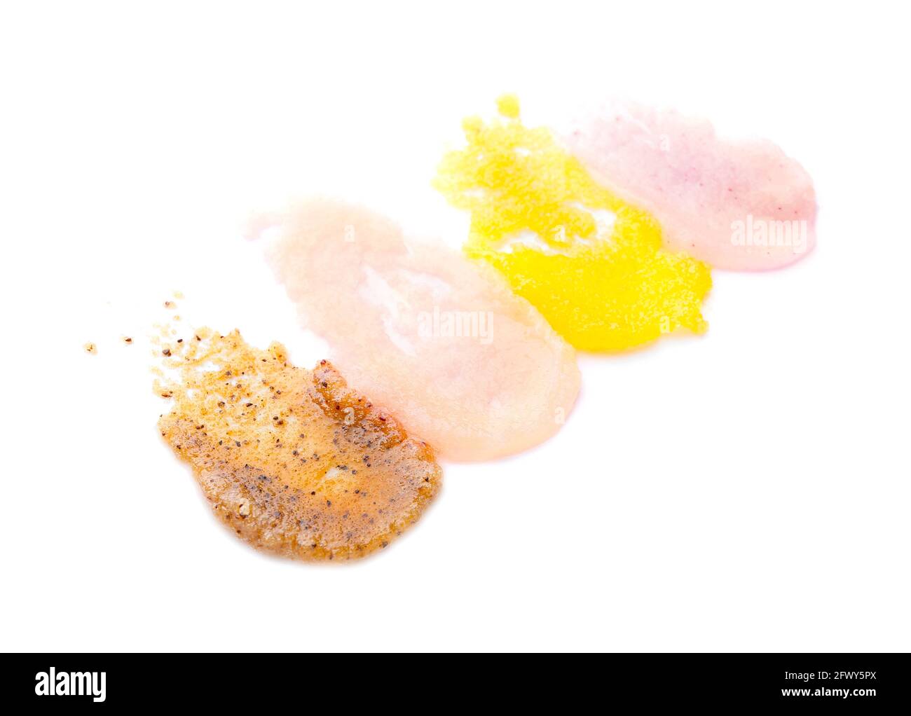 Samples of body scrub on white background Stock Photo - Alamy