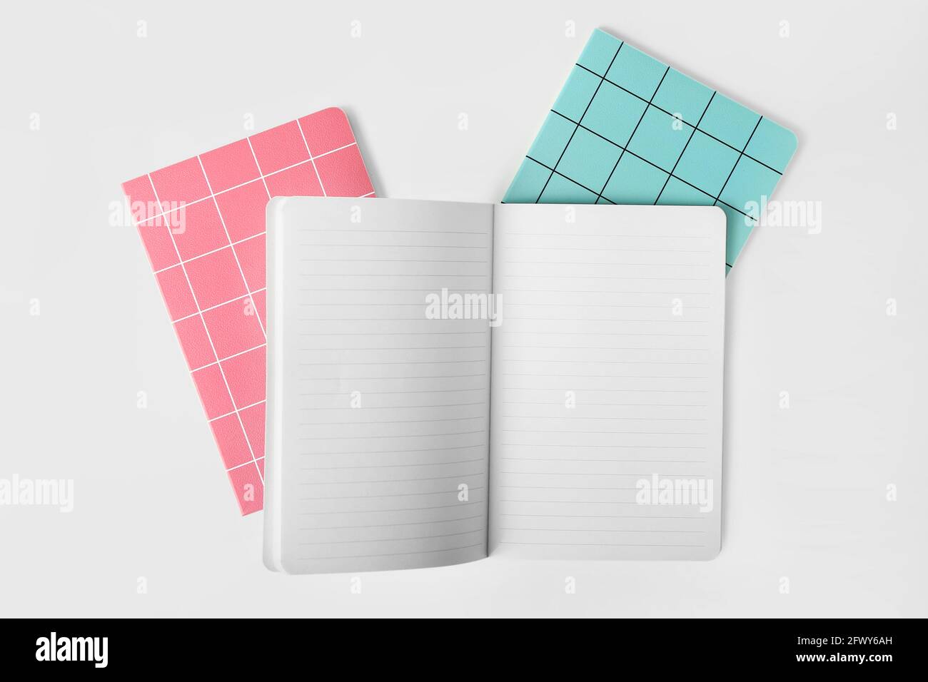 Checkered notebooks on white background Stock Photo - Alamy