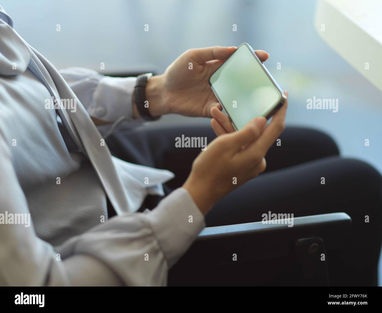 Side view of female hand holding horizontal smartphone while relaxing ...