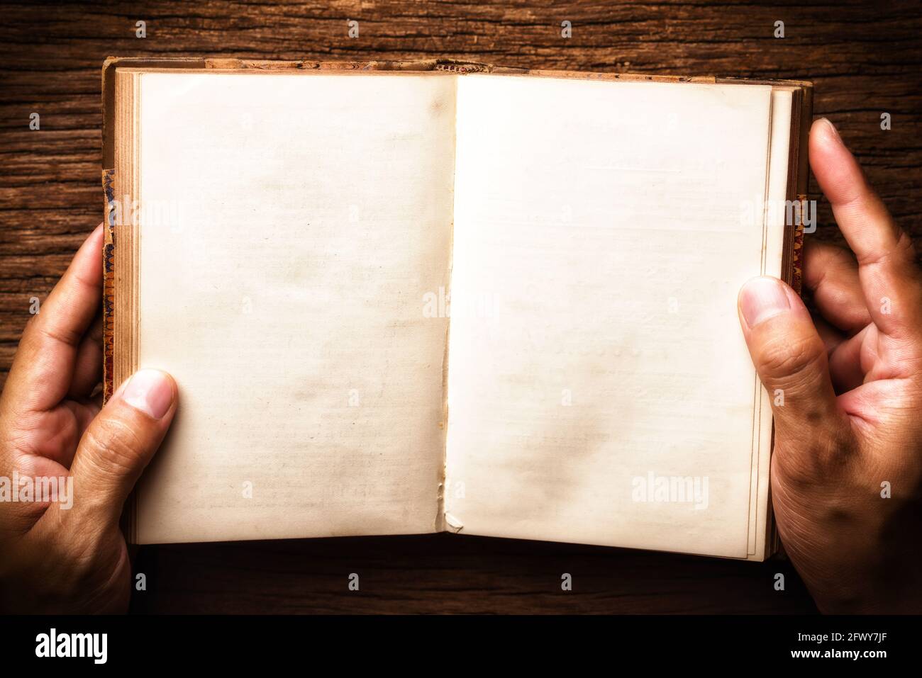The man opening a vintage book with blank pages Stock Photo - Alamy