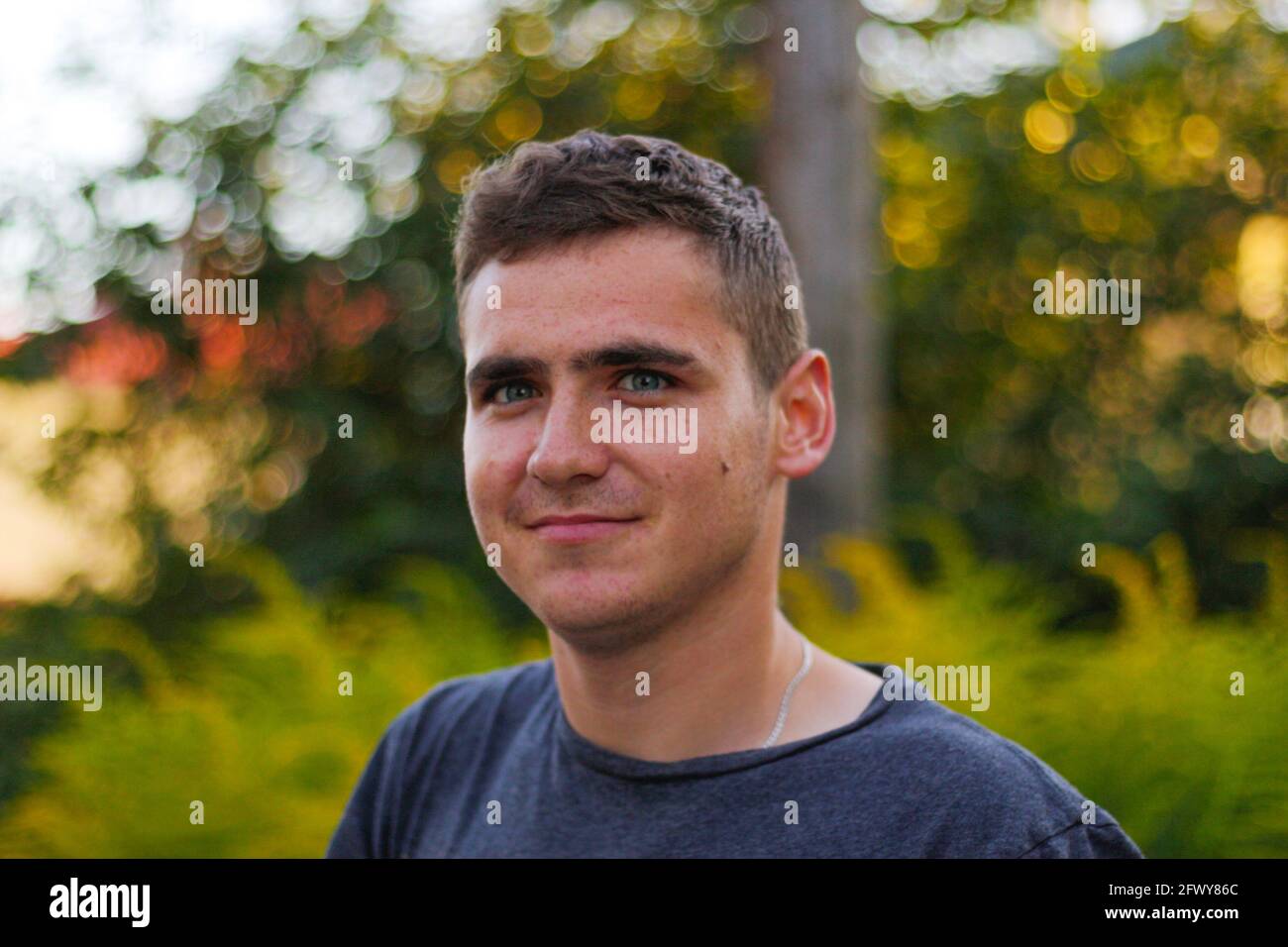 Defocus handsome caucasian young man outdoors portrait. Man smiling ... Defocus handsome caucasian young man outdoors portrait. Man smiling ...