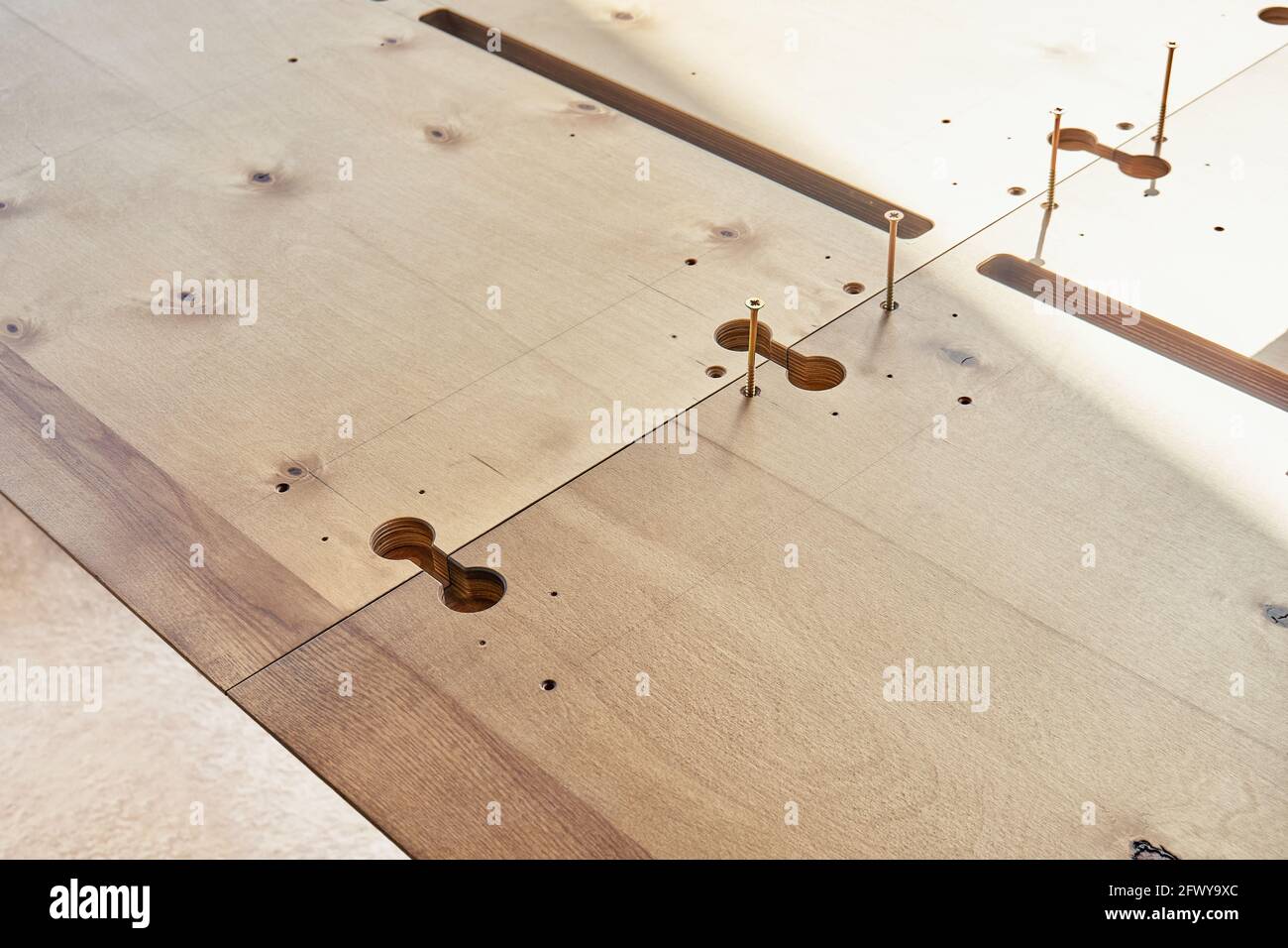 Assembling of large wooden dining table with worktop connectors and ...