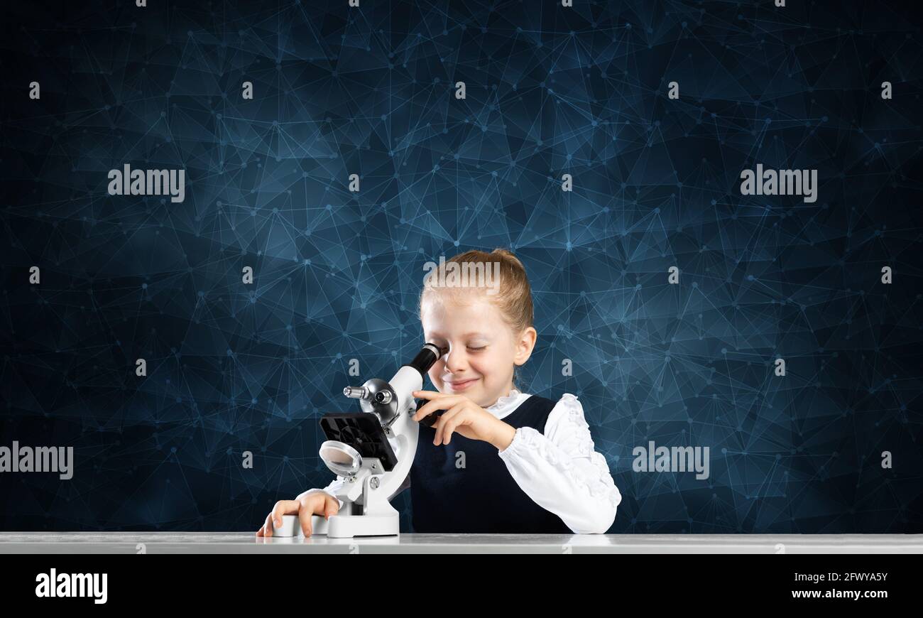 Little scientist looking through microscope Stock Photo - Alamy
