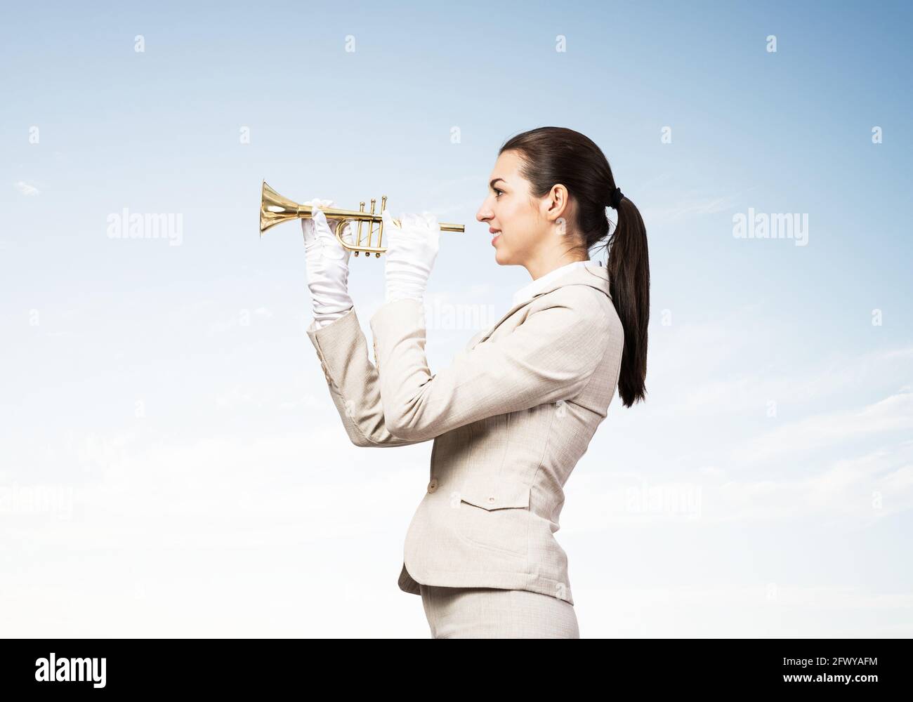 Beautiful woman playing trumpet brass Stock Photo - Alamy