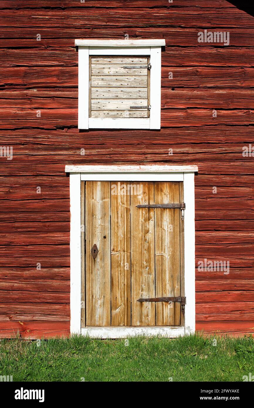 An old hatch above a wooden door in an old wooden farm building wall ...