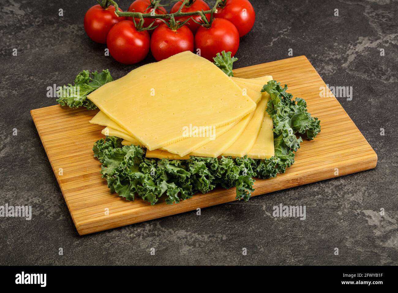 Sliced Gauda cheese snack over board Stock Photo - Alamy