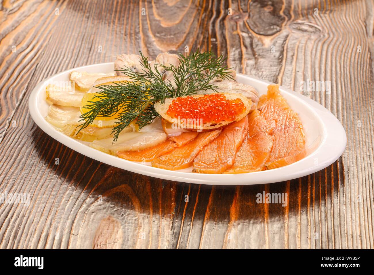 Sliced fish mix plate appetiser with caviar Stock Photo - Alamy
