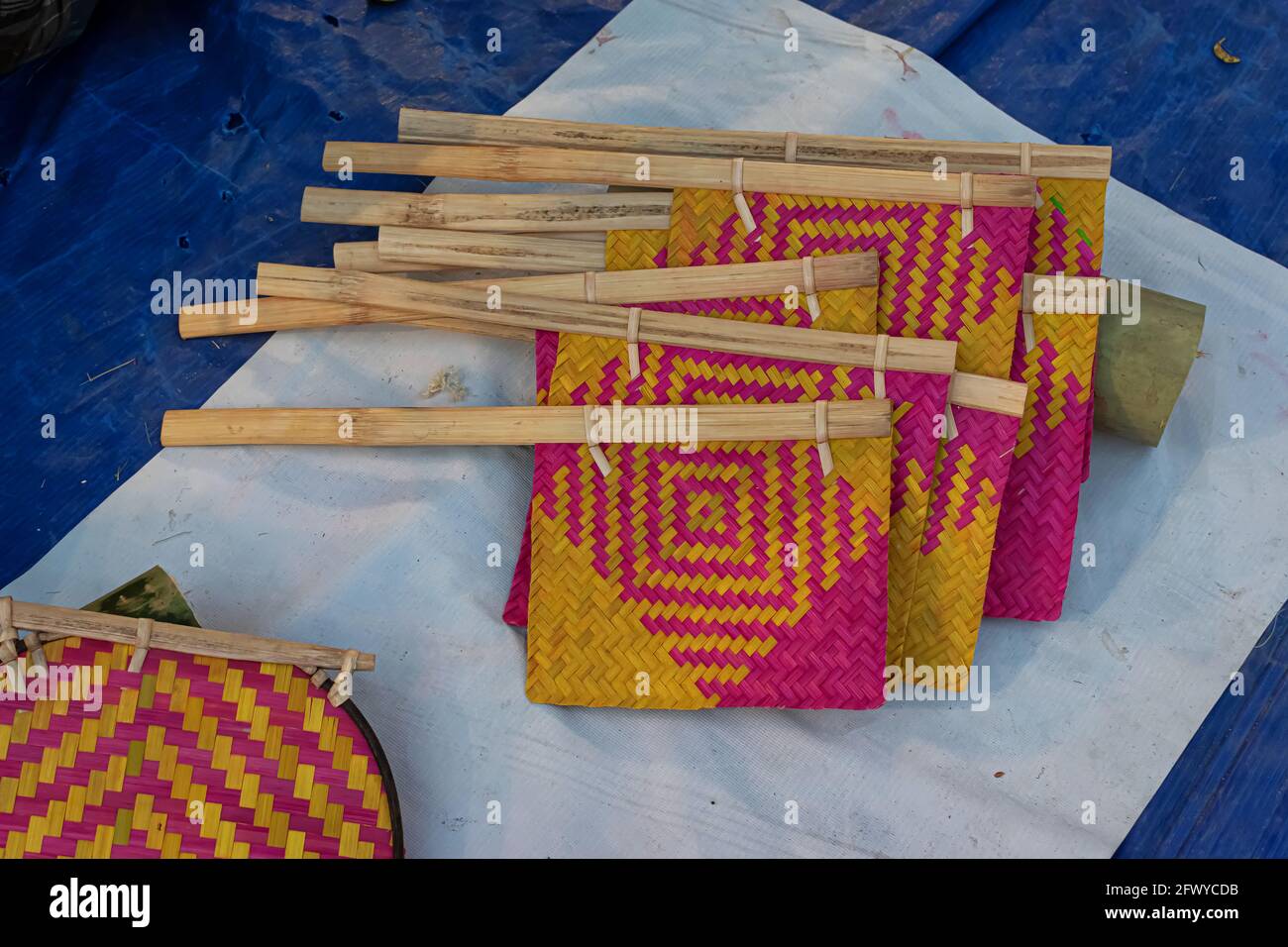 Beautiful handmade hand fan made by bamboo is displayed in a shop for ...