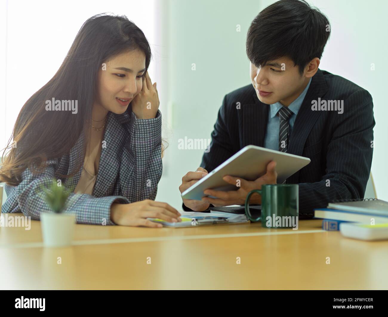 Portraits of businesspeople talking to each other while discussing on ...