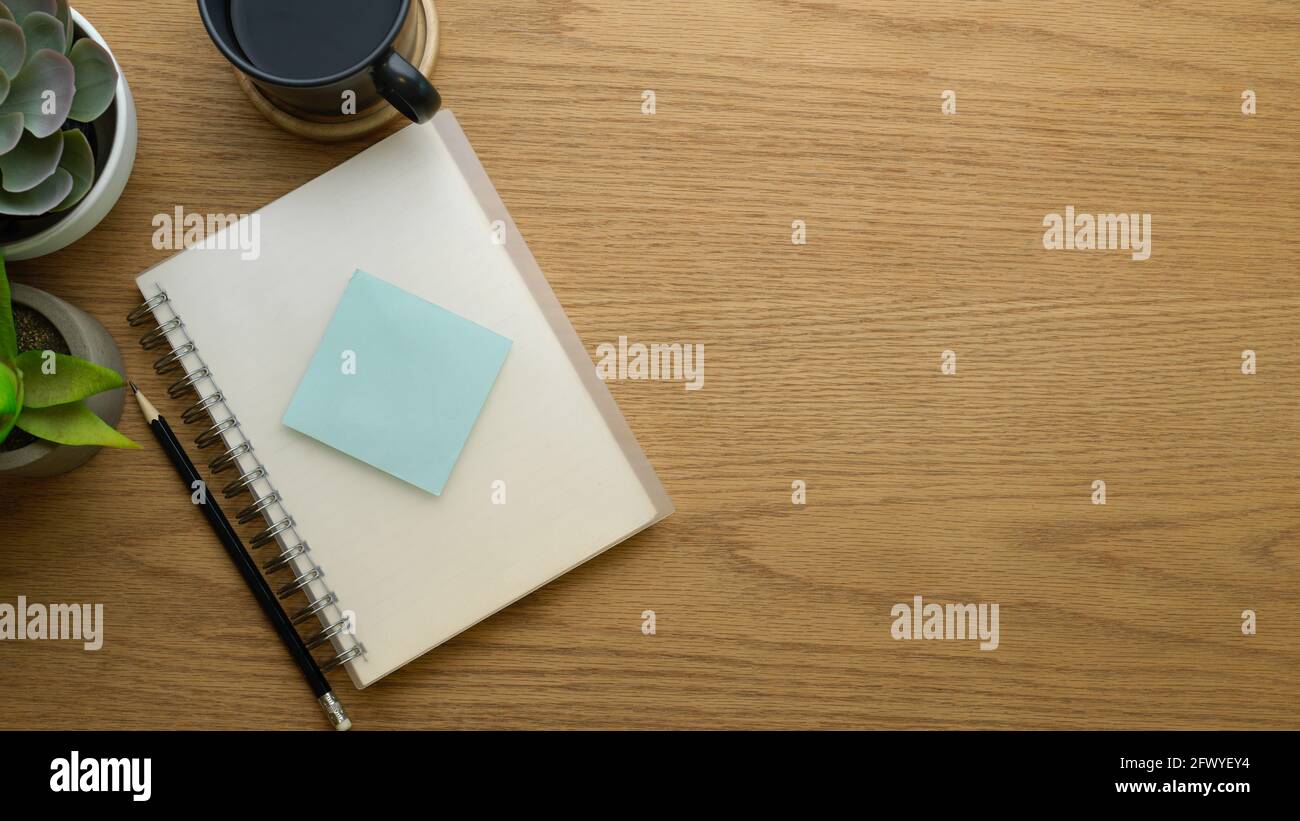 Top view of notebook, pencil, sticky note, coffee cup and copy space on ...