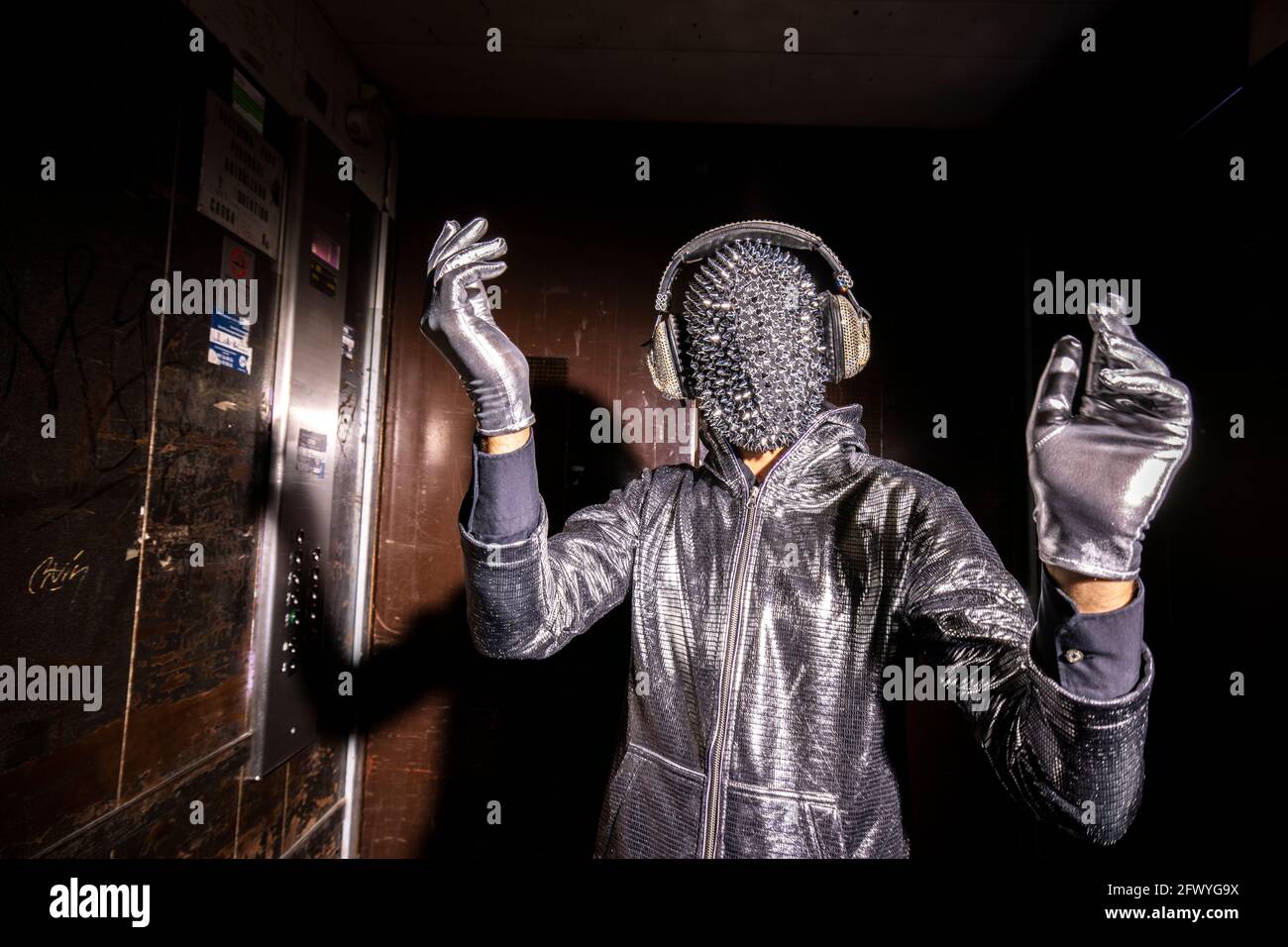 Sparkle masked man dancing in a lift Stock Photo - Alamy