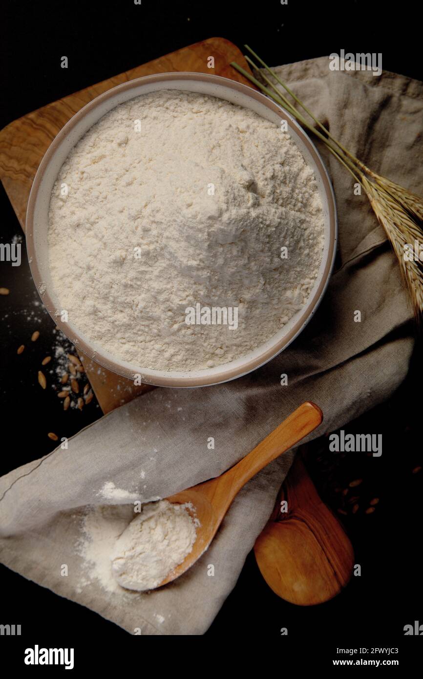 Wheat flour on dark background. Food preparing concept. Top view Stock ...