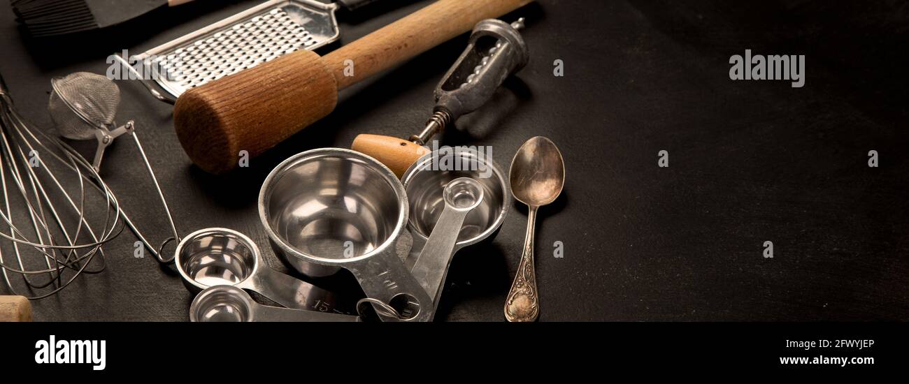 Set of kitchen utensils on black background. Tools for cooking ...