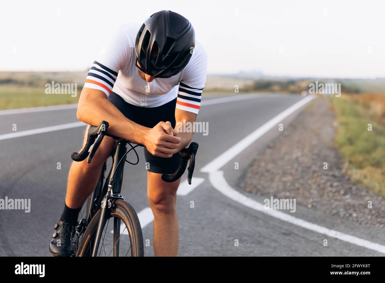 Relaxed cyclist in activewear sitting on bike outdoors Stock Photo - Alamy