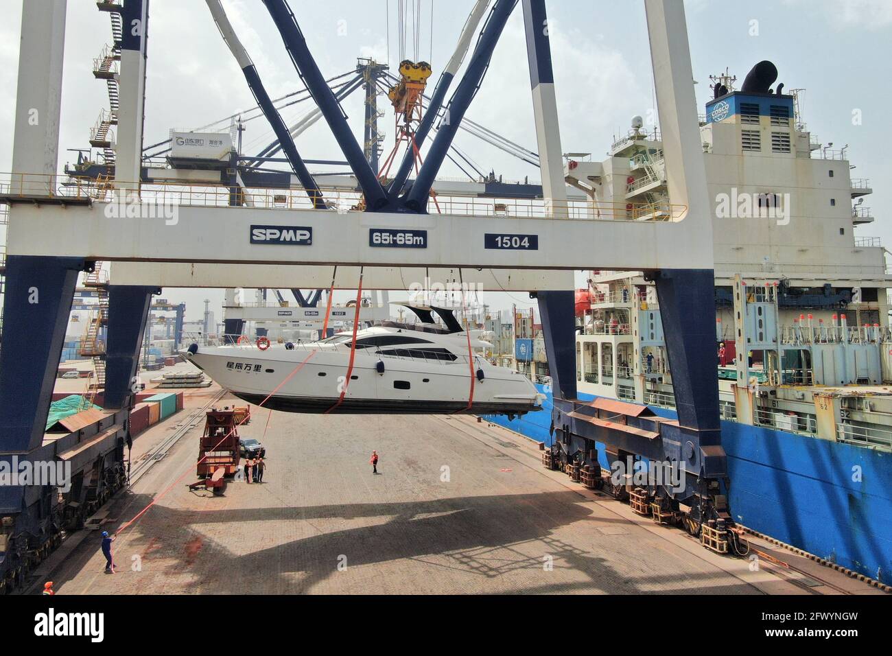 YANTAI, CHINA - MAY 24, 2021 - Xingchenwanli yacht is lifted from ...