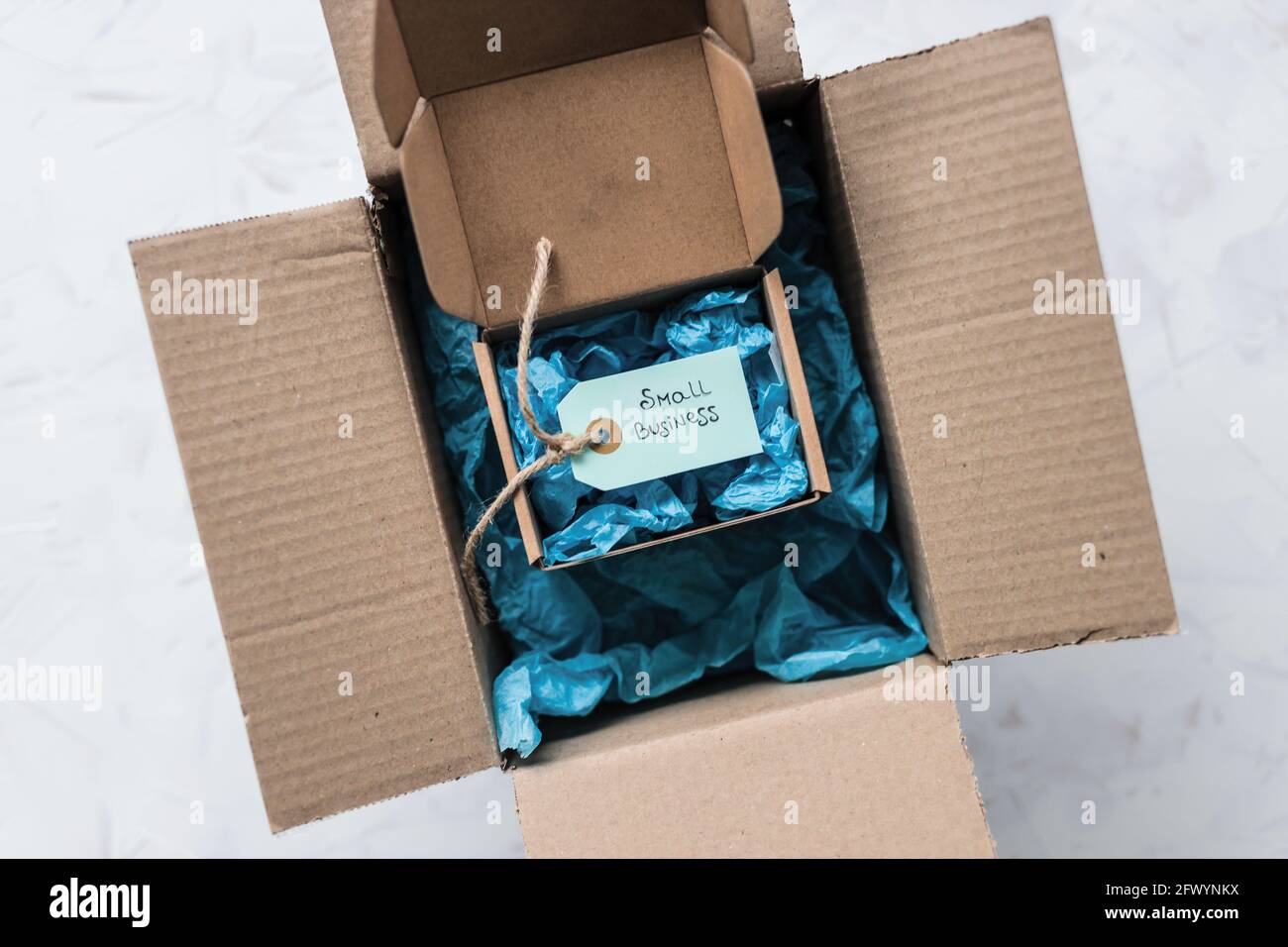 product tag with small business text inside ofsmaller delivery parcel ...