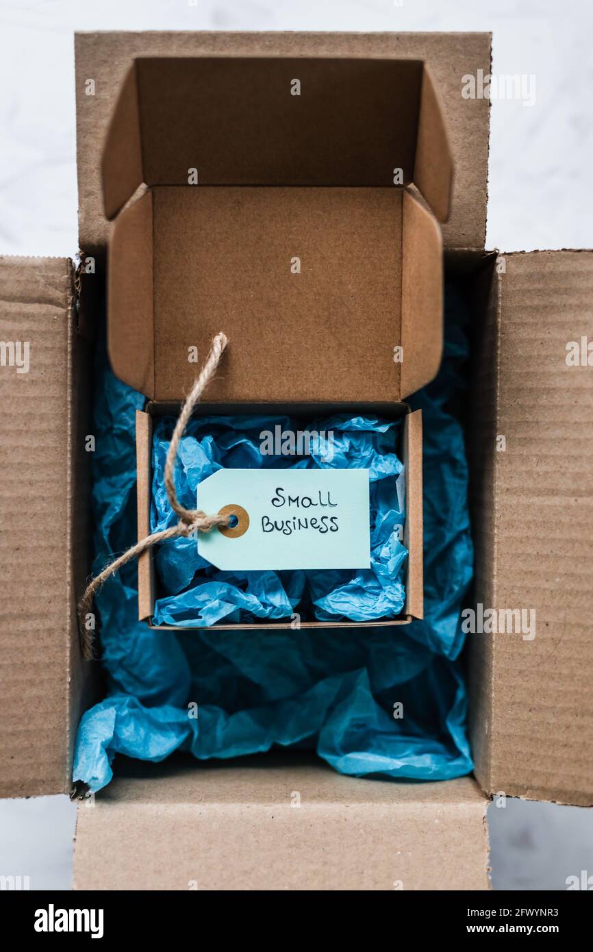 product tag with small business text inside ofsmaller delivery parcel ...