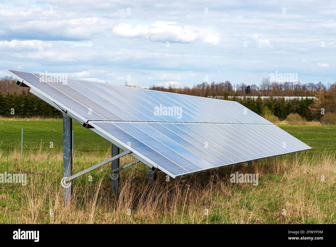 Solar panels in a field.Long line of solar electric generation panels ...