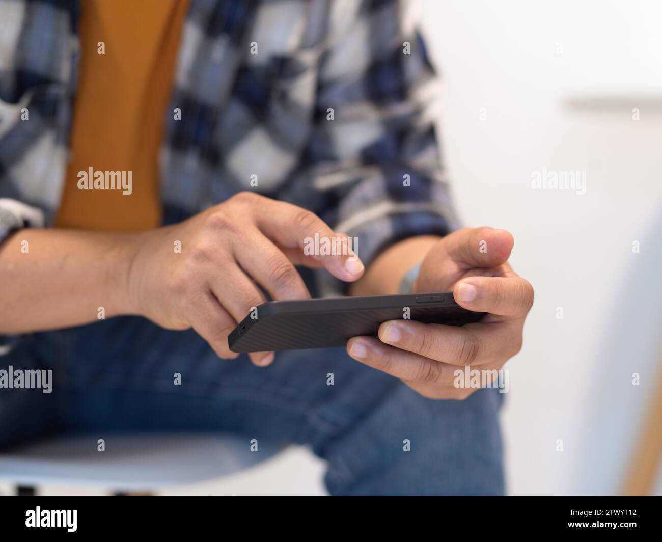 Side view of a man touching on horizontal smartphone screen, using ...