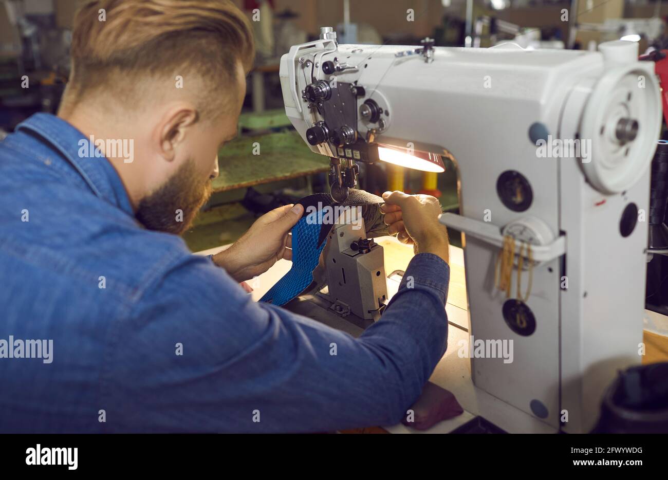 Man sitting at sewing machine hi-res stock photography and images - Alamy