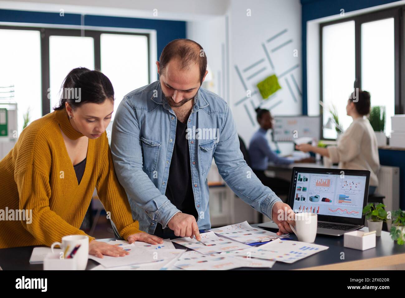 Company management working on important deadline in startup office ...