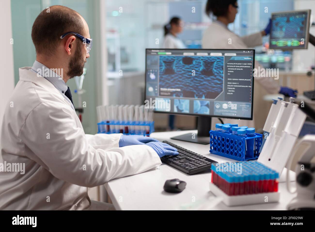 Man scientist working to develop a new vaccine in modern equipped ...