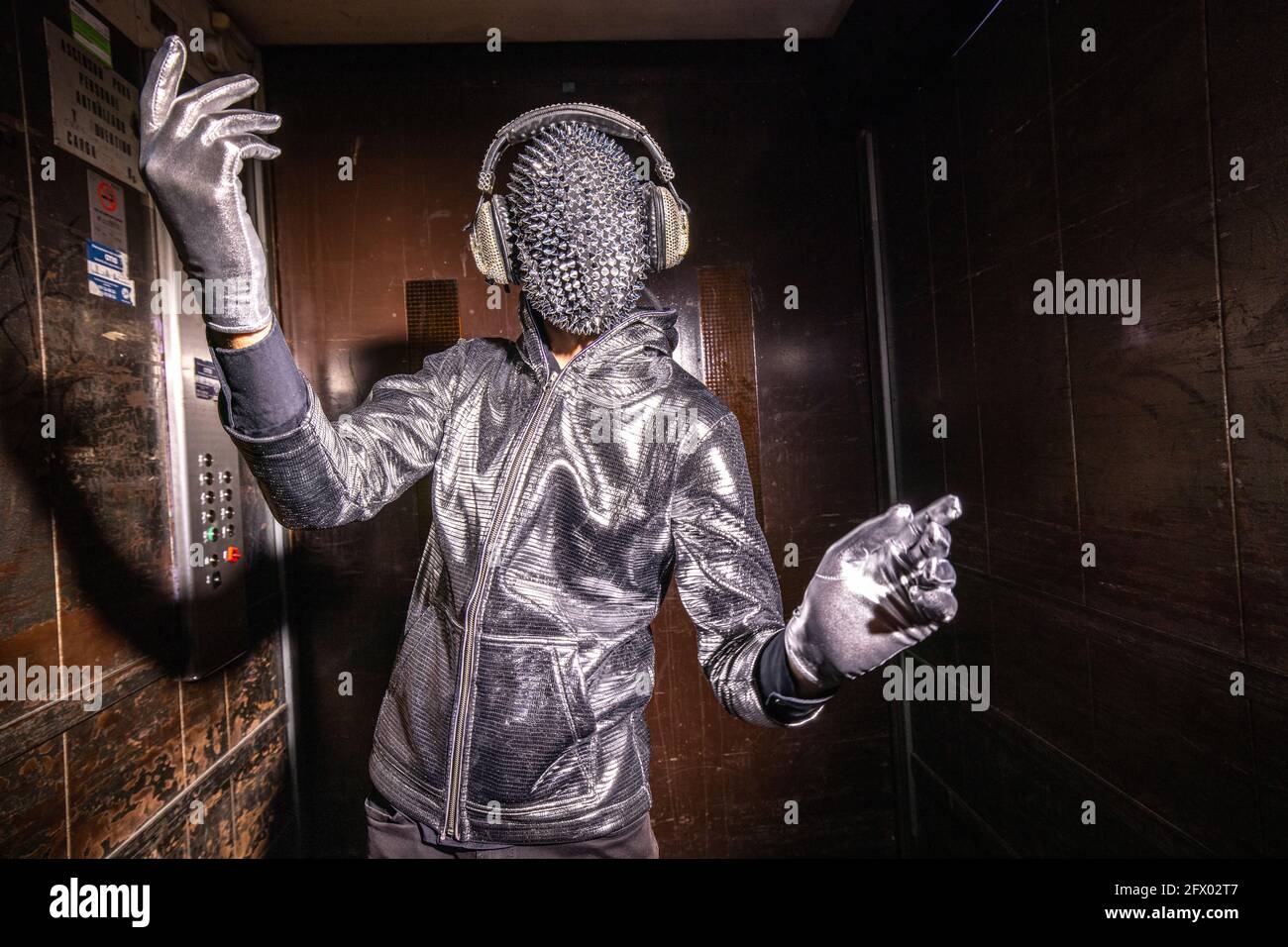 Sparkle masked man dancing in a lift Stock Photo - Alamy