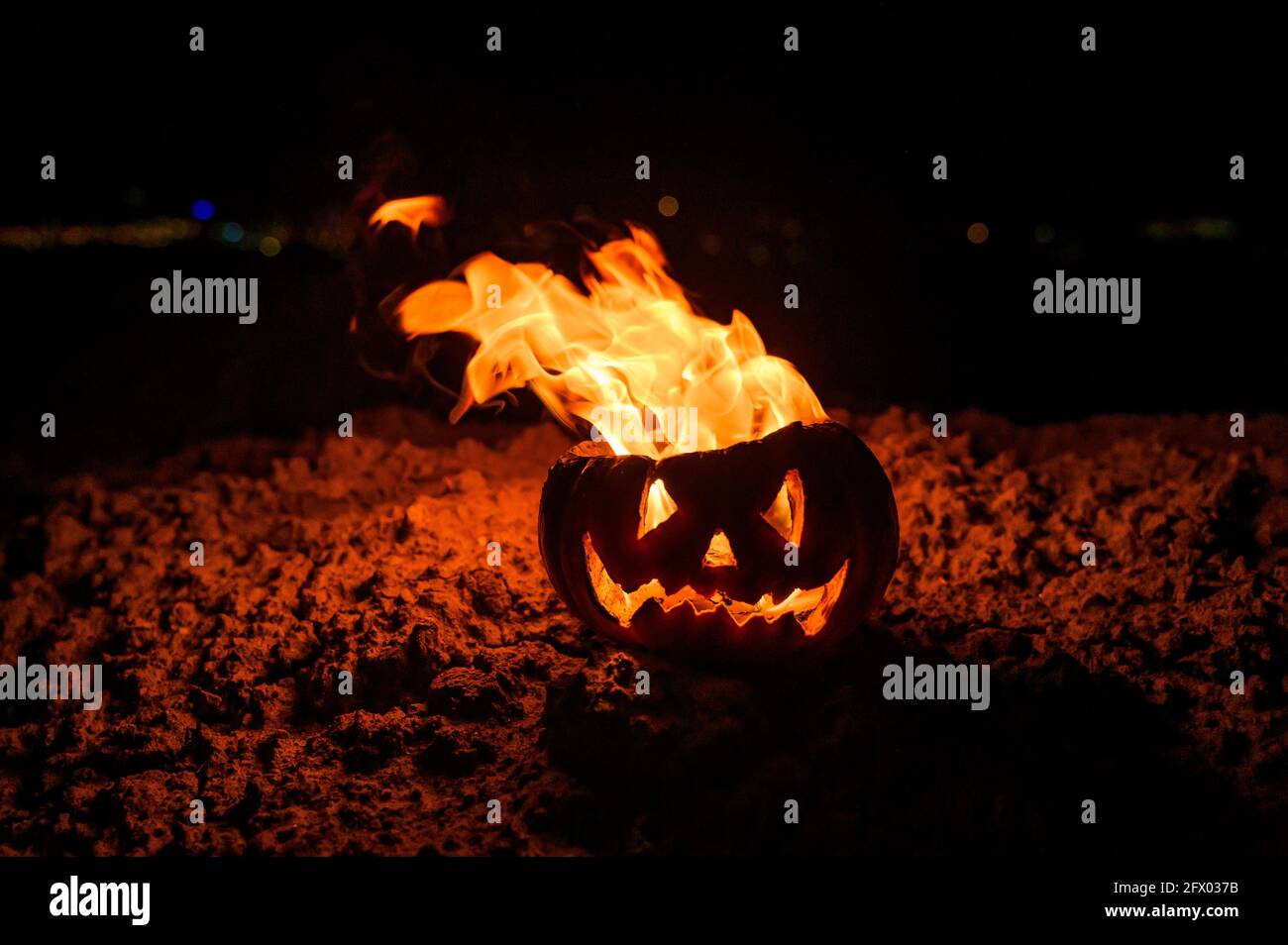 Tongues of flame in a pumpkin. jack-o-lantern on fire on a black ...