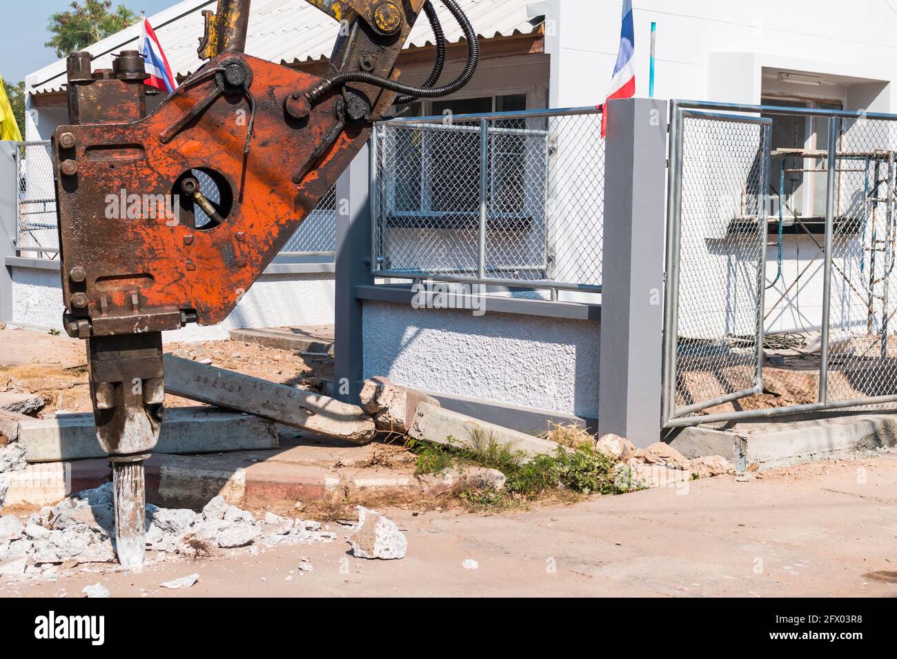 Machine pneumatic hammer drill breaking asphalt concreat at road on hot ...
