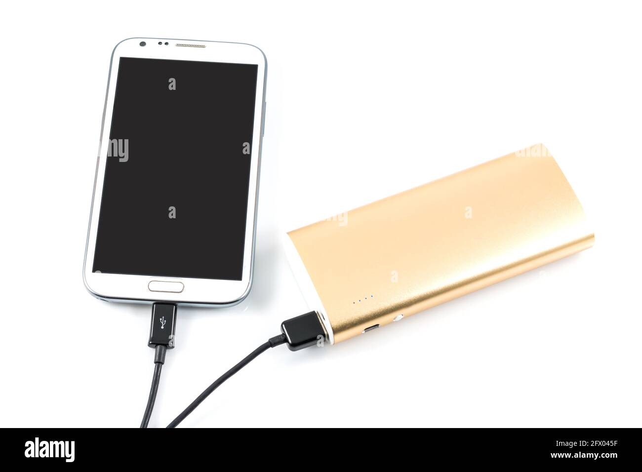 Gold power bank charging white smart phone on white background Stock ...