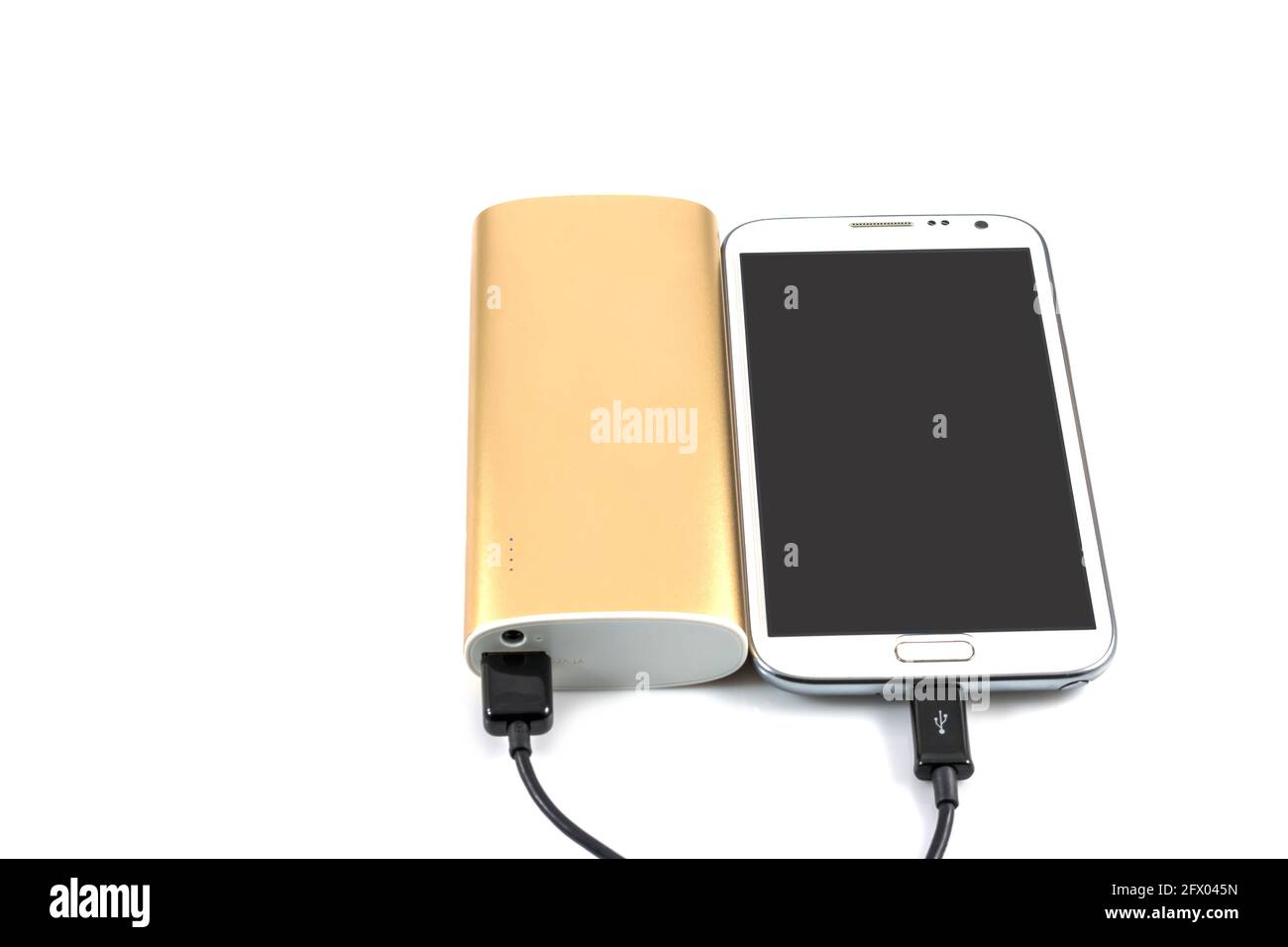 Gold power bank charging white smart phone on white background Stock ...