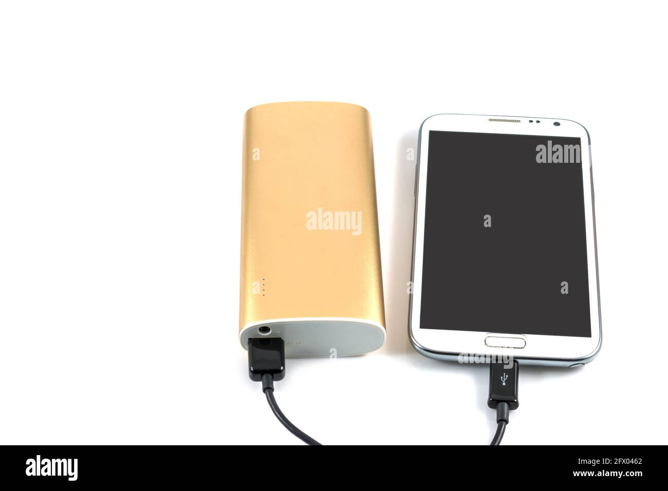 Gold power bank charging white smart phone on white background Stock ...