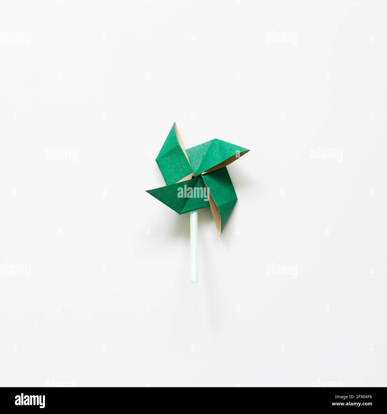 Green paper pinwheel isolated on white background. top view Stock Photo ...