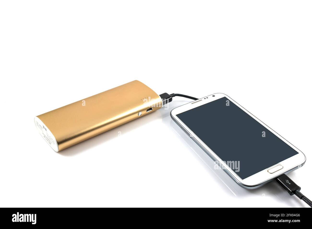 Gold power bank charging white smart phone on white background Stock ...