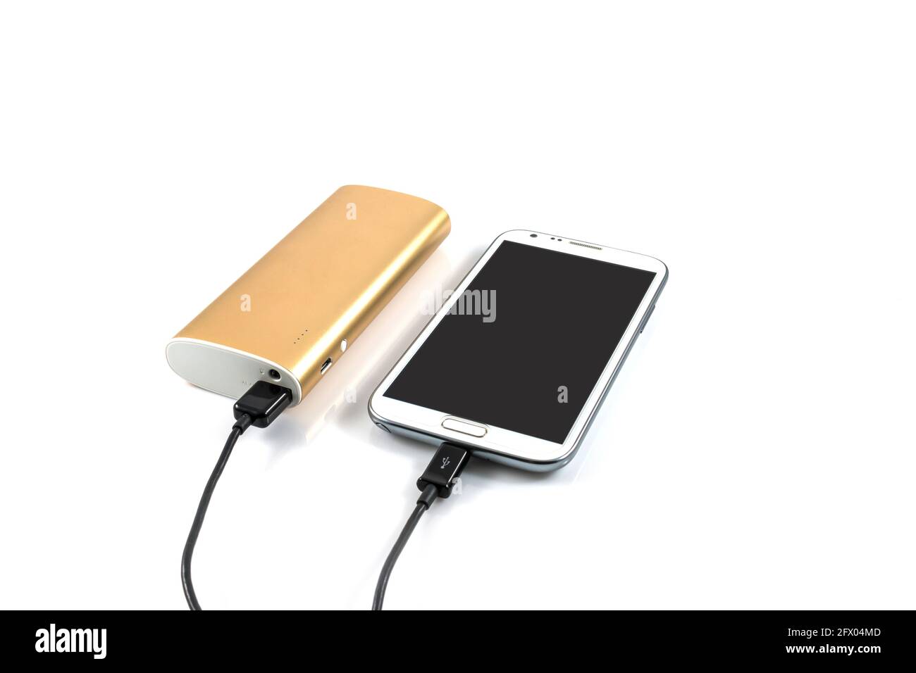 Gold power bank charging white smart phone on white background Stock ...