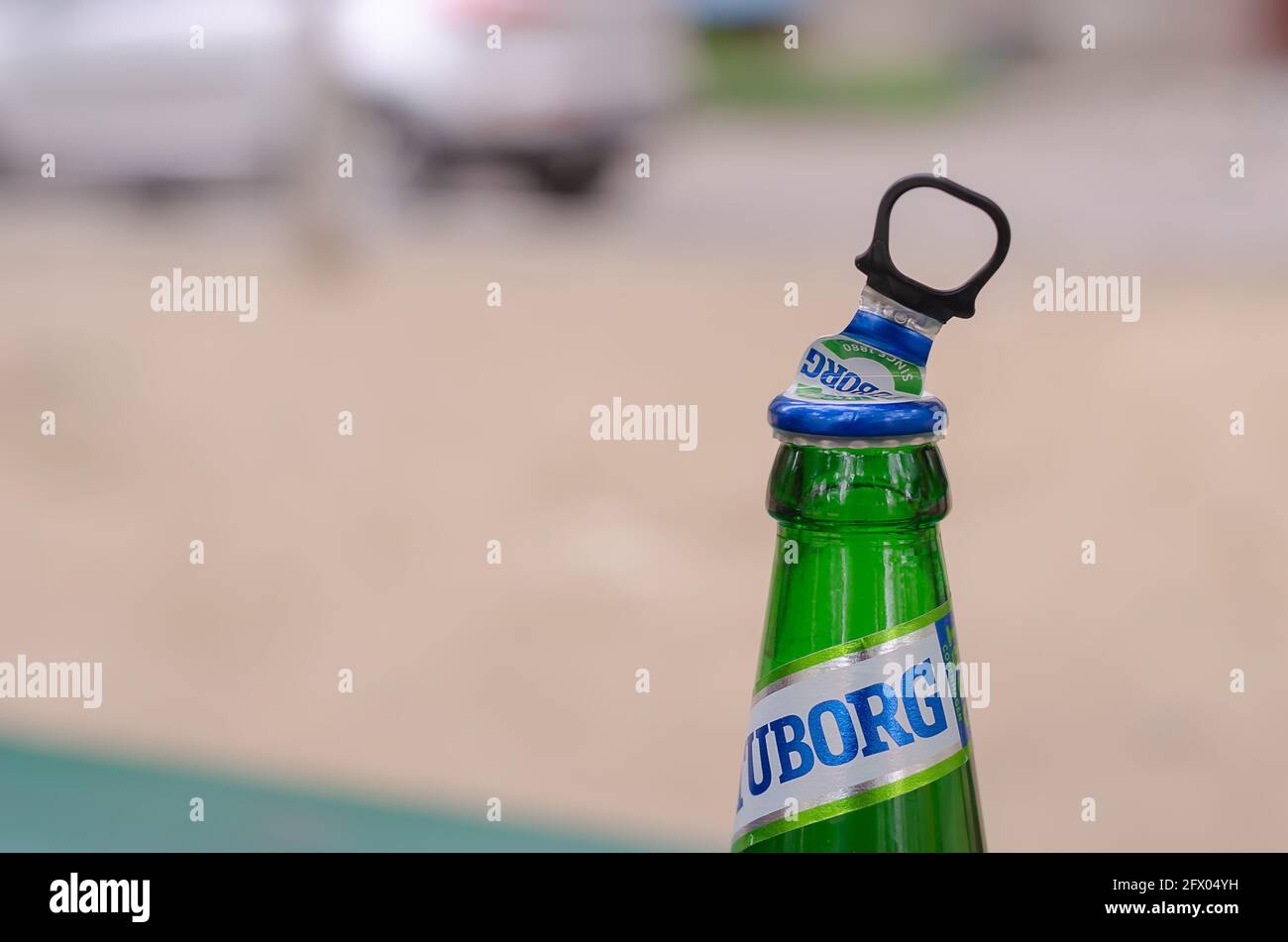 One beer Tuborg Green with open stopper close-up. Beer bottle of the ...