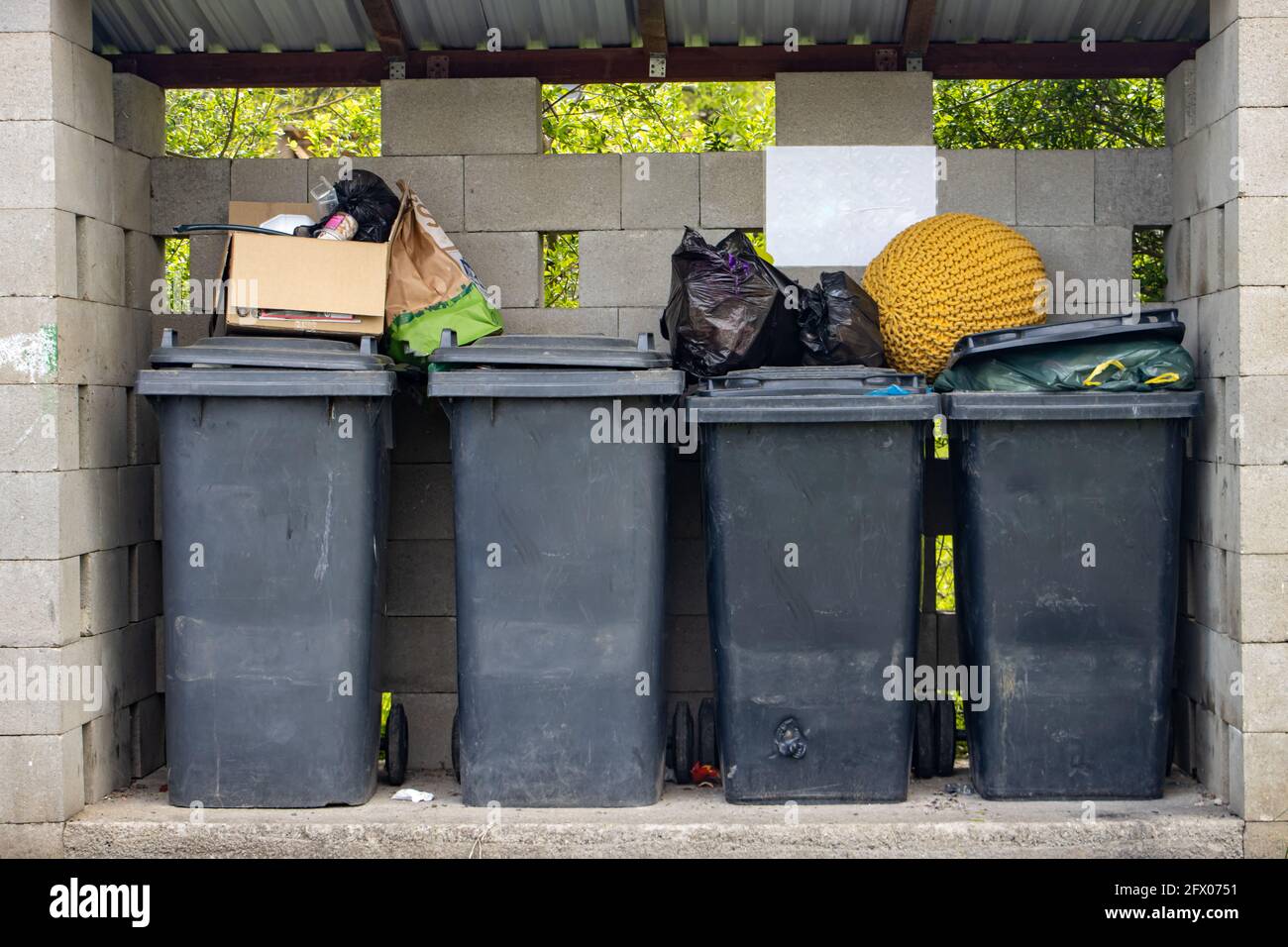 A row of full trash cans in a shelter Stock Photo - Alamy
