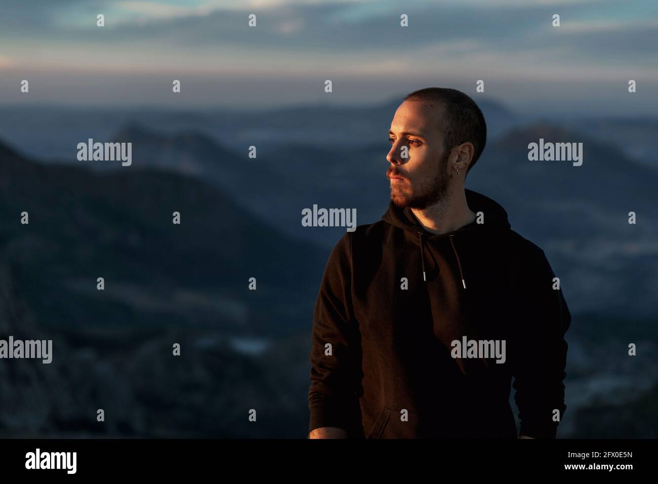 Anonymous female in multicolored masquerade mask with flowers on head ...