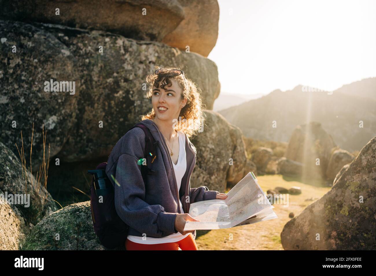 Side view of happy young female explorer with dark hair in casual ...