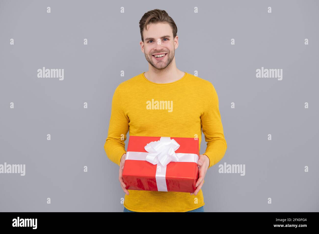 Making present. Happy guy hold present box Stock Photo - Alamy