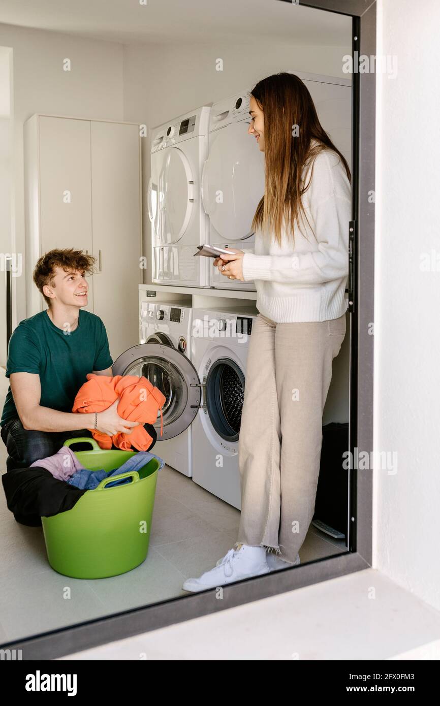 Home laundry smiling guy using hi-res stock photography and images - Alamy