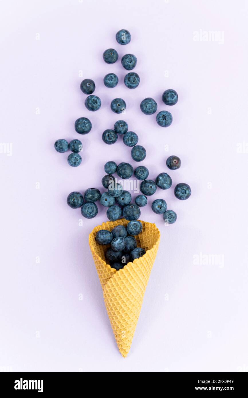 Ice cream cone with blueberries. Blueberry icecream. Healthy summer ...