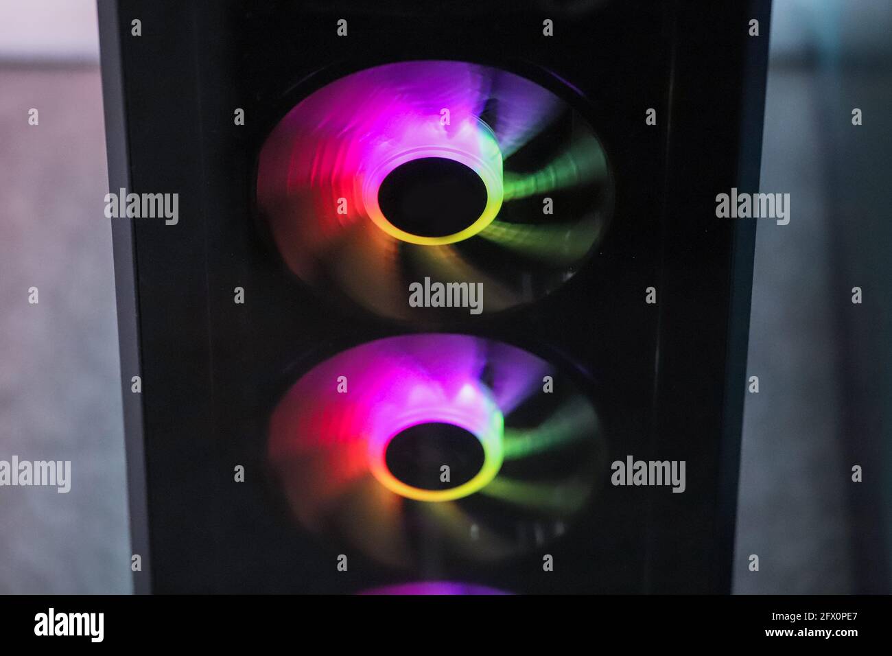 Pink illumination of a cooler PC system unit. Computer fan with LED ...