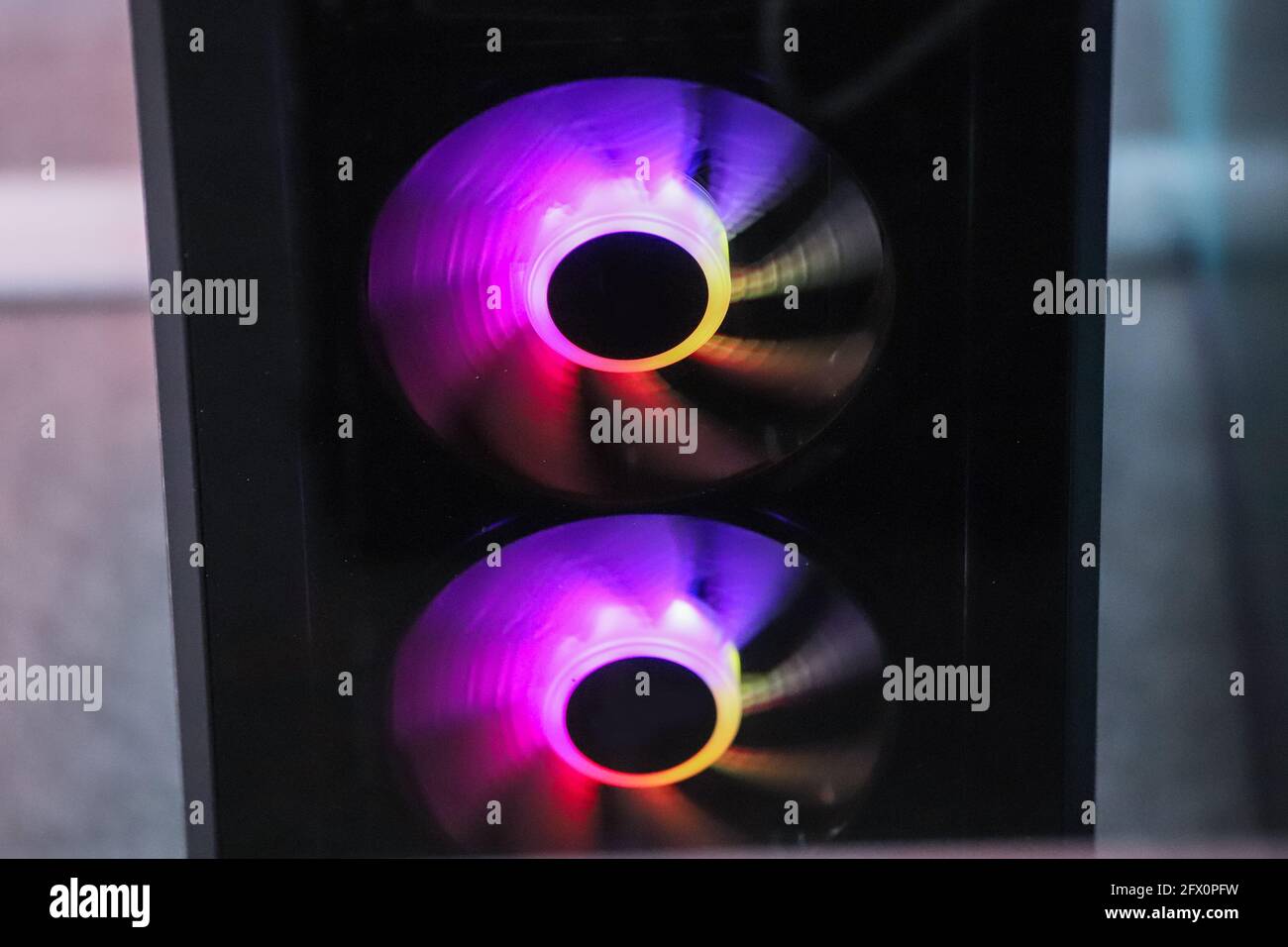 Pink illumination of a cooler PC system unit. Computer fan with LED ...